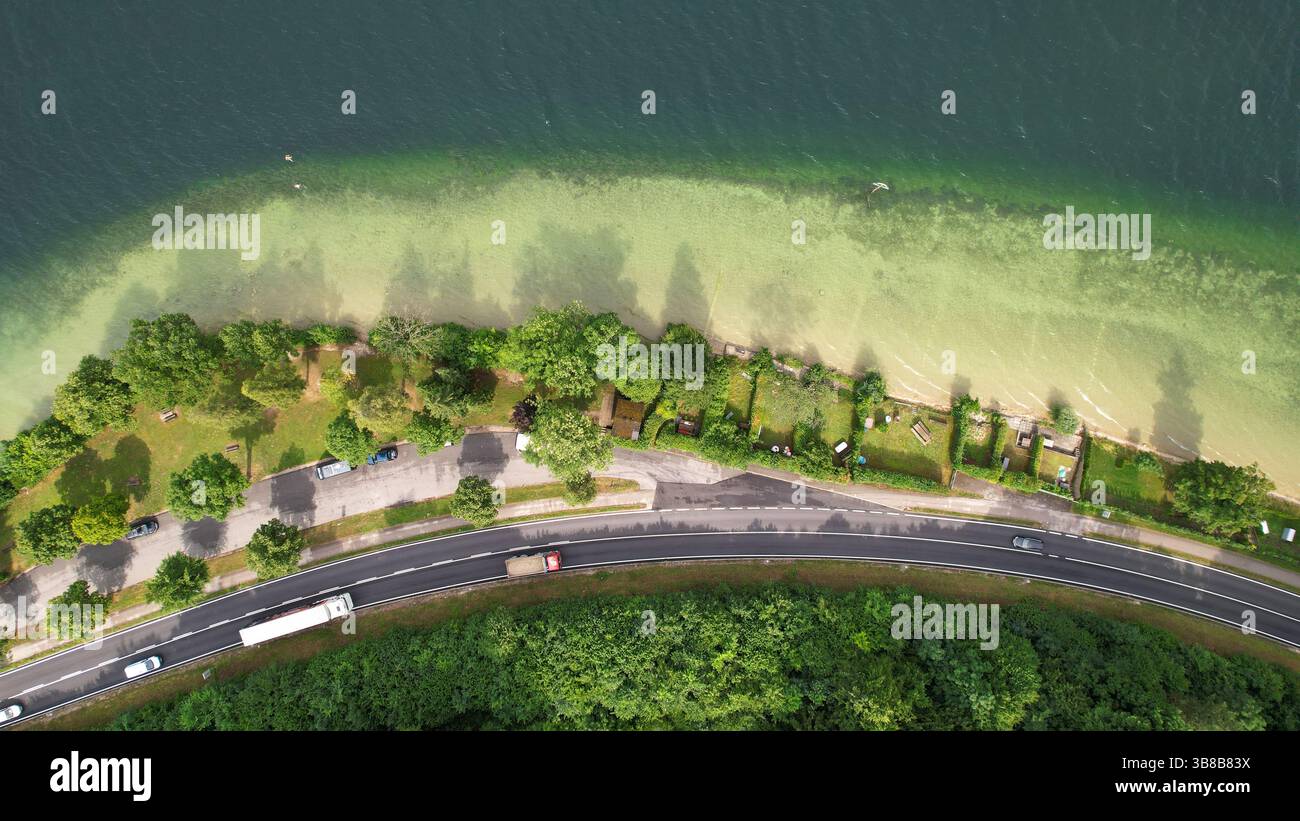 Aerial View of Lakeside Road with Crystal Water and Lush Trees Stock ...