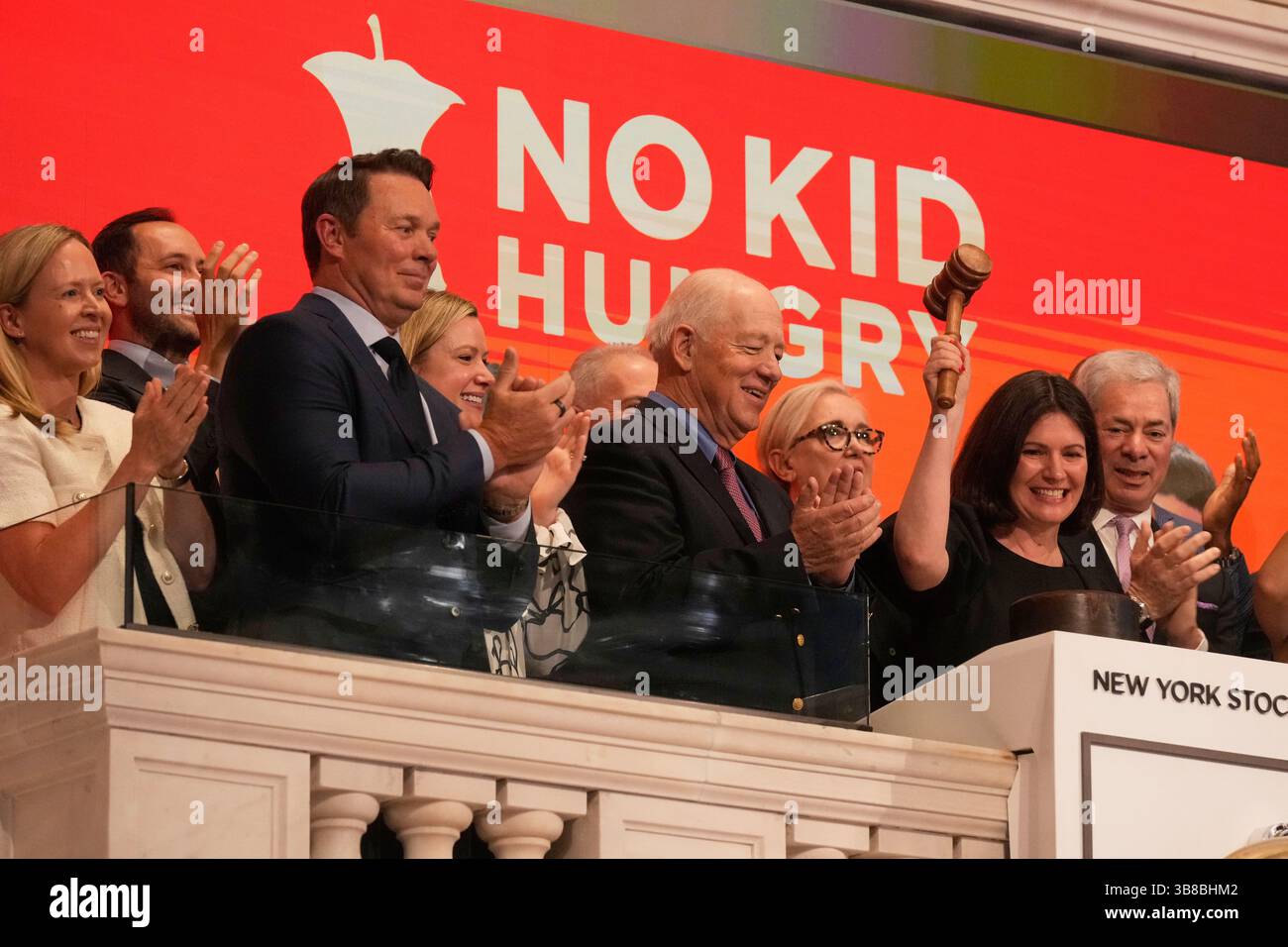 Anne Filipic, CEO of Share Our Strength, right, gavels trading closed ...