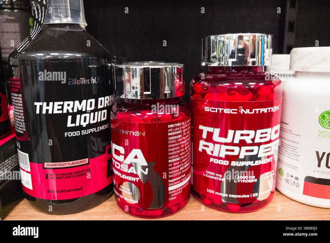 Minsk, Belarus - April 28, 2025: Shelves filled with colorful bottles of supplements showcase ...