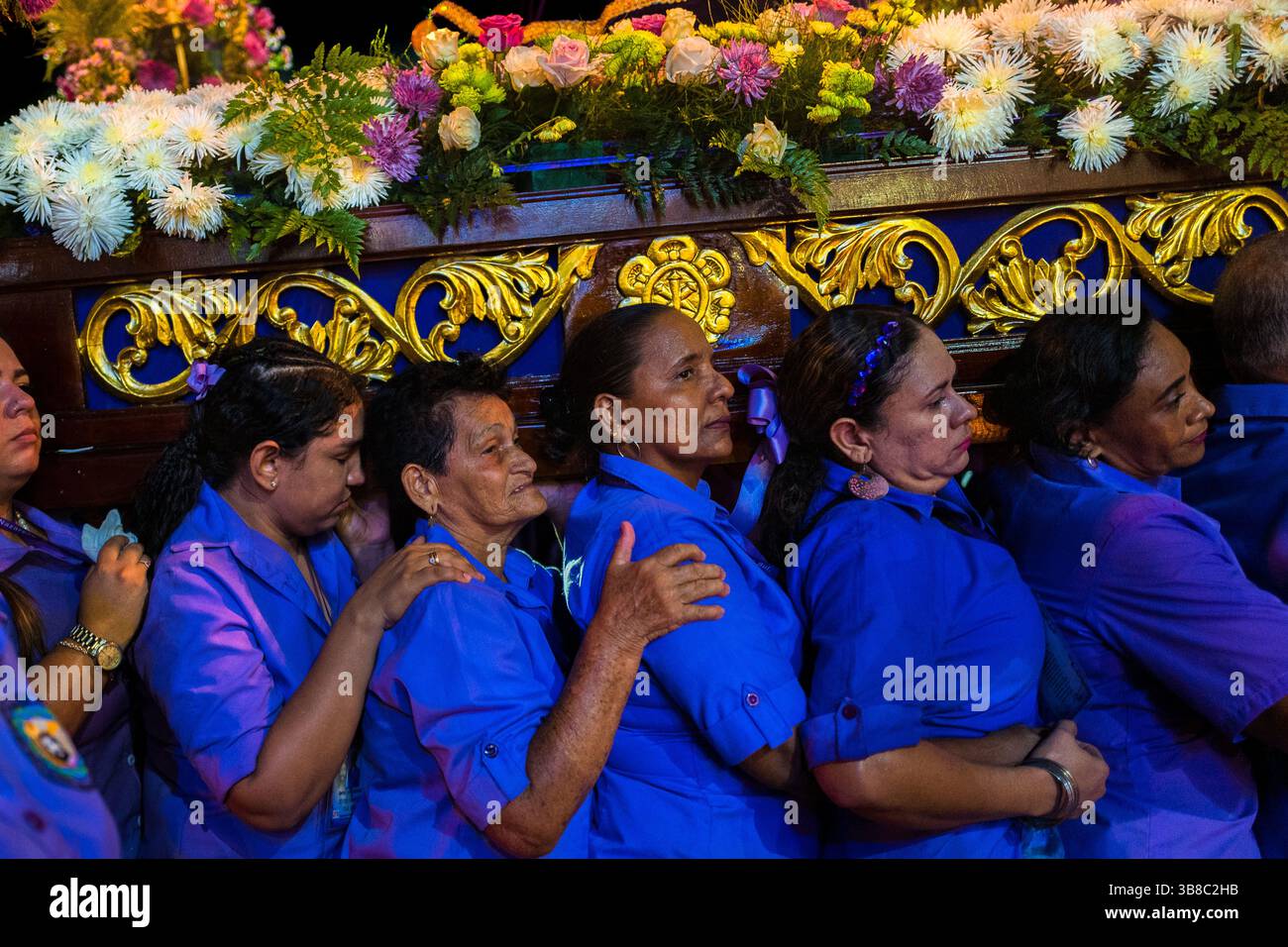 Female Catholic devotees, members of a religious brotherhood, carry a ...