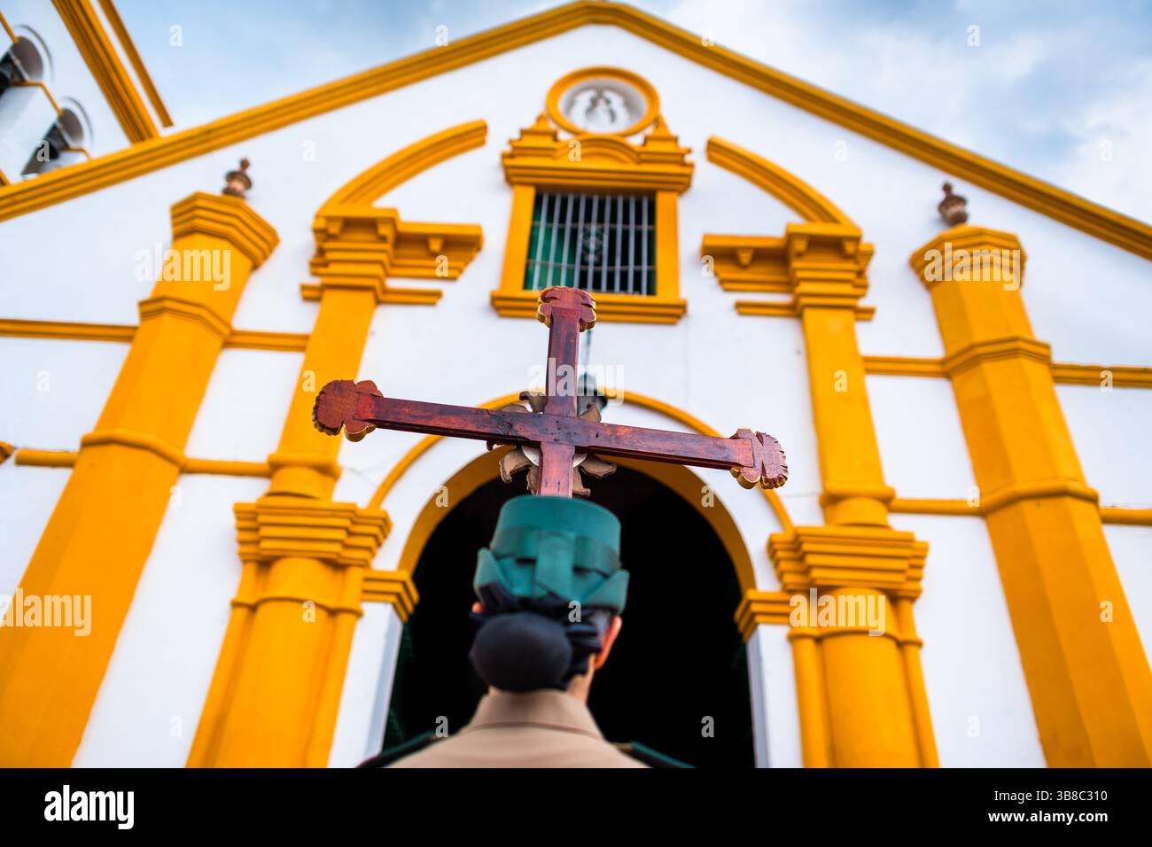 A member of the Colombian National Police carries a cross as she ...