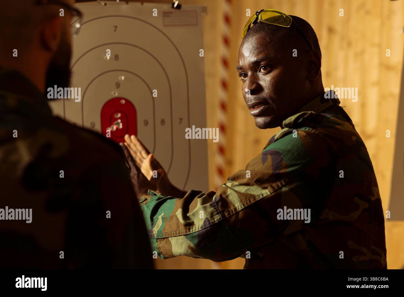 Army general at shooting range training soldiers to learn how to hit ...