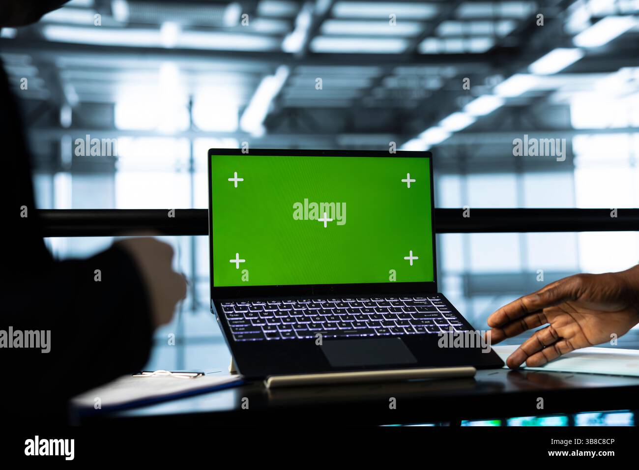 Programmers in data center using mockup laptop, inspecting server rigs ...