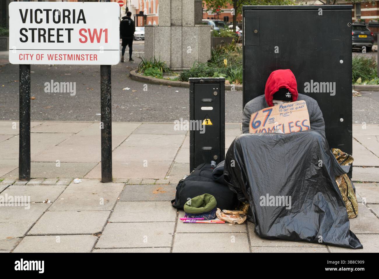 On Victoria Street, London, a 67-year-old homeless person sits by a ...