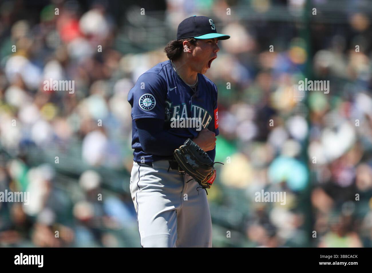 Seattle Mariners pitcher Bryan Woo reacts after getting a strike out ...