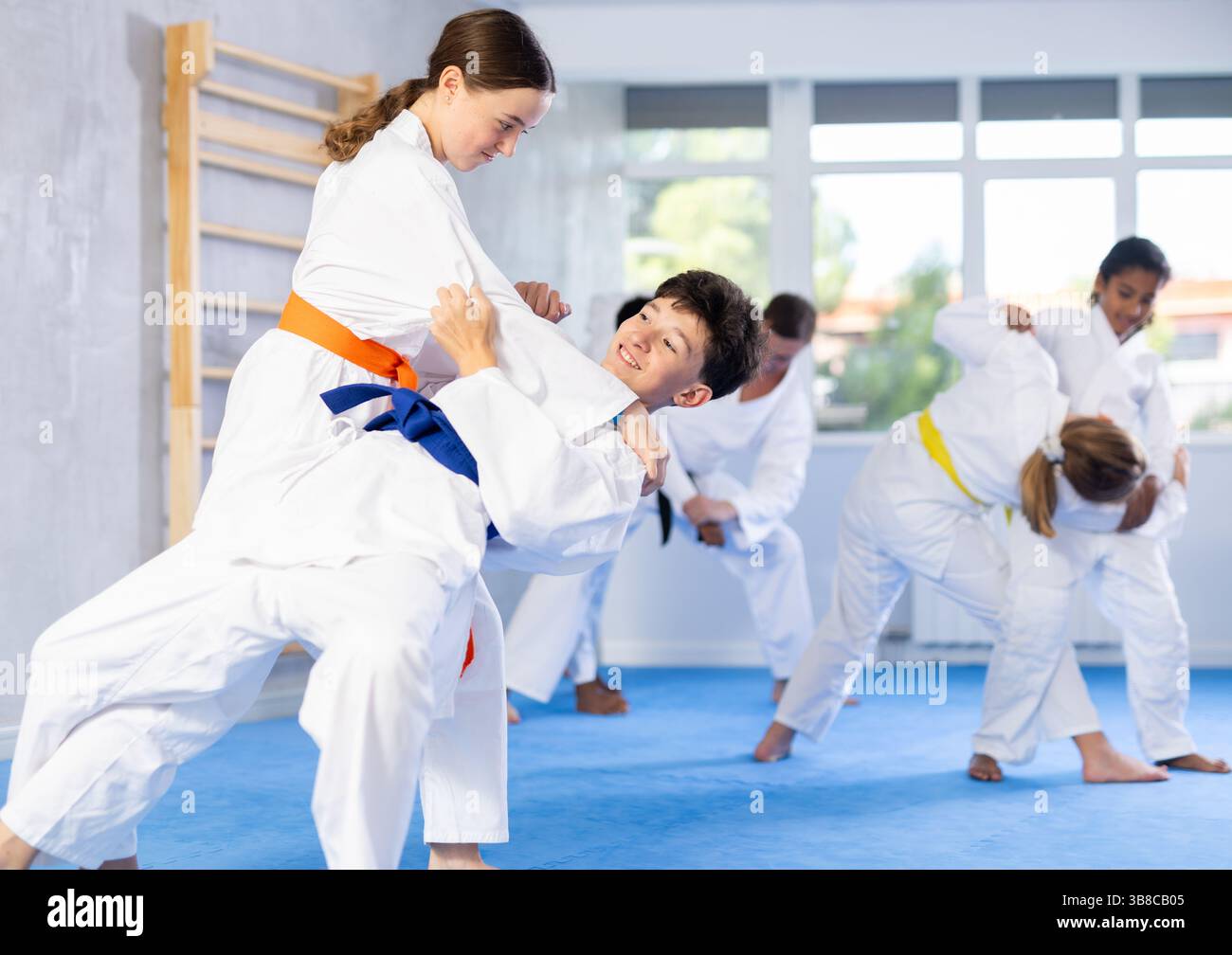 Boy and girl training judo technique Stock Photo - Alamy