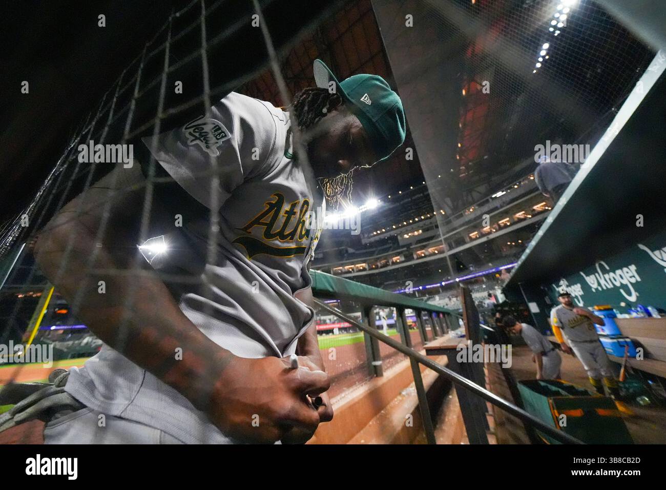Athletics outfielder Lawrence Butler sings autographs following a ...