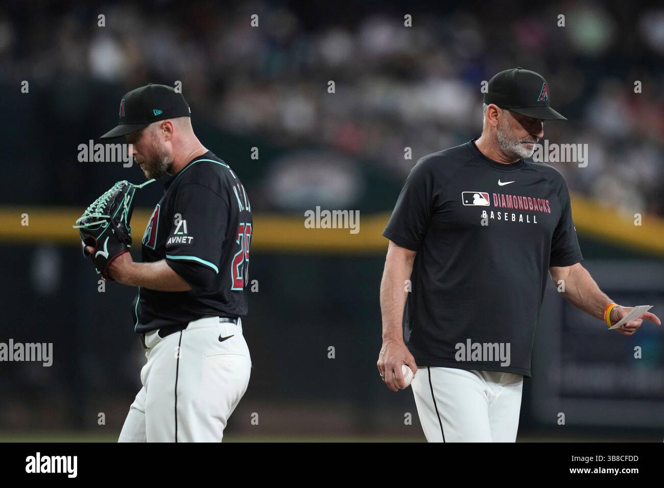 Arizona Diamondbacks manager Torey Lovullo, right, takes the ball from ...