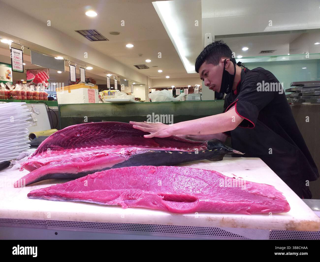Fresh raw whole tuna fish being carved ready to be sold Stock Photo - Alamy