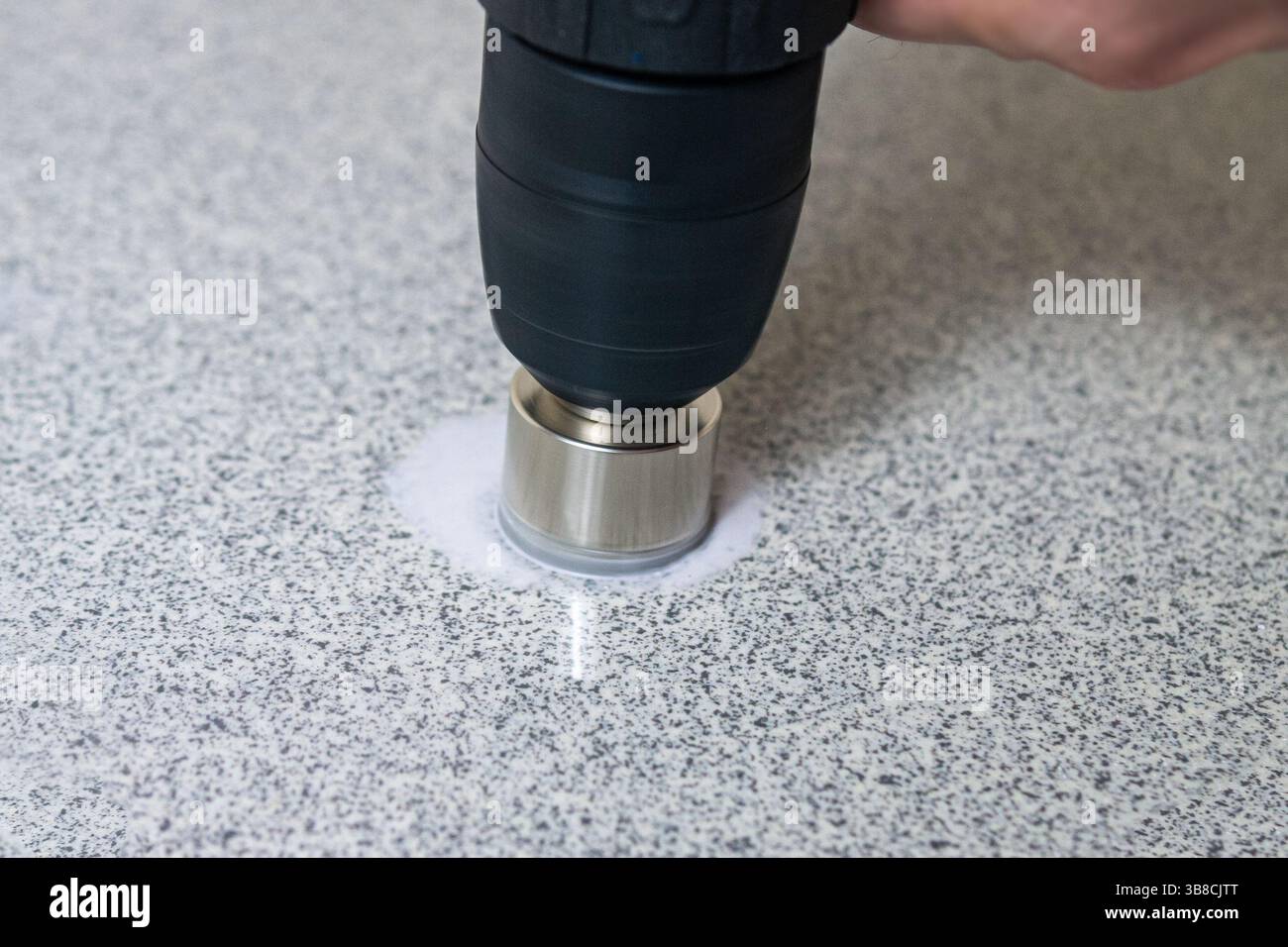 rotating diamond core hole cutter in hand power drill drills stone slab ...