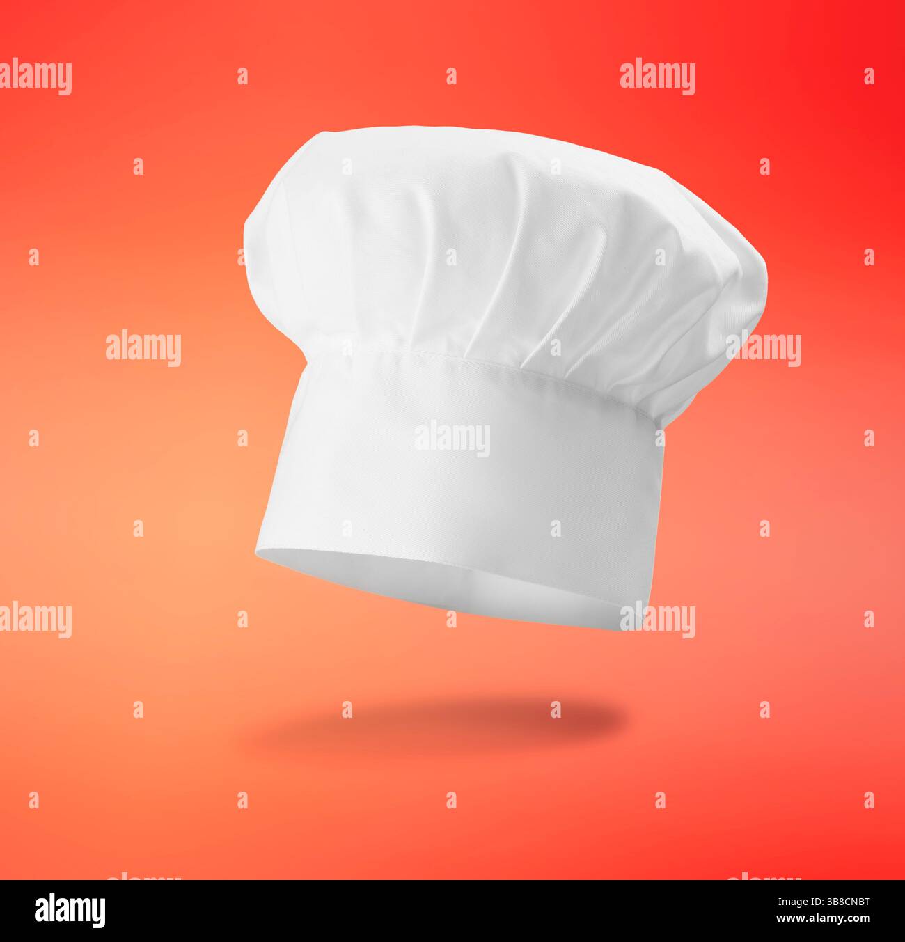 White chef's hat in air on red gradient background. Part of traditional ...