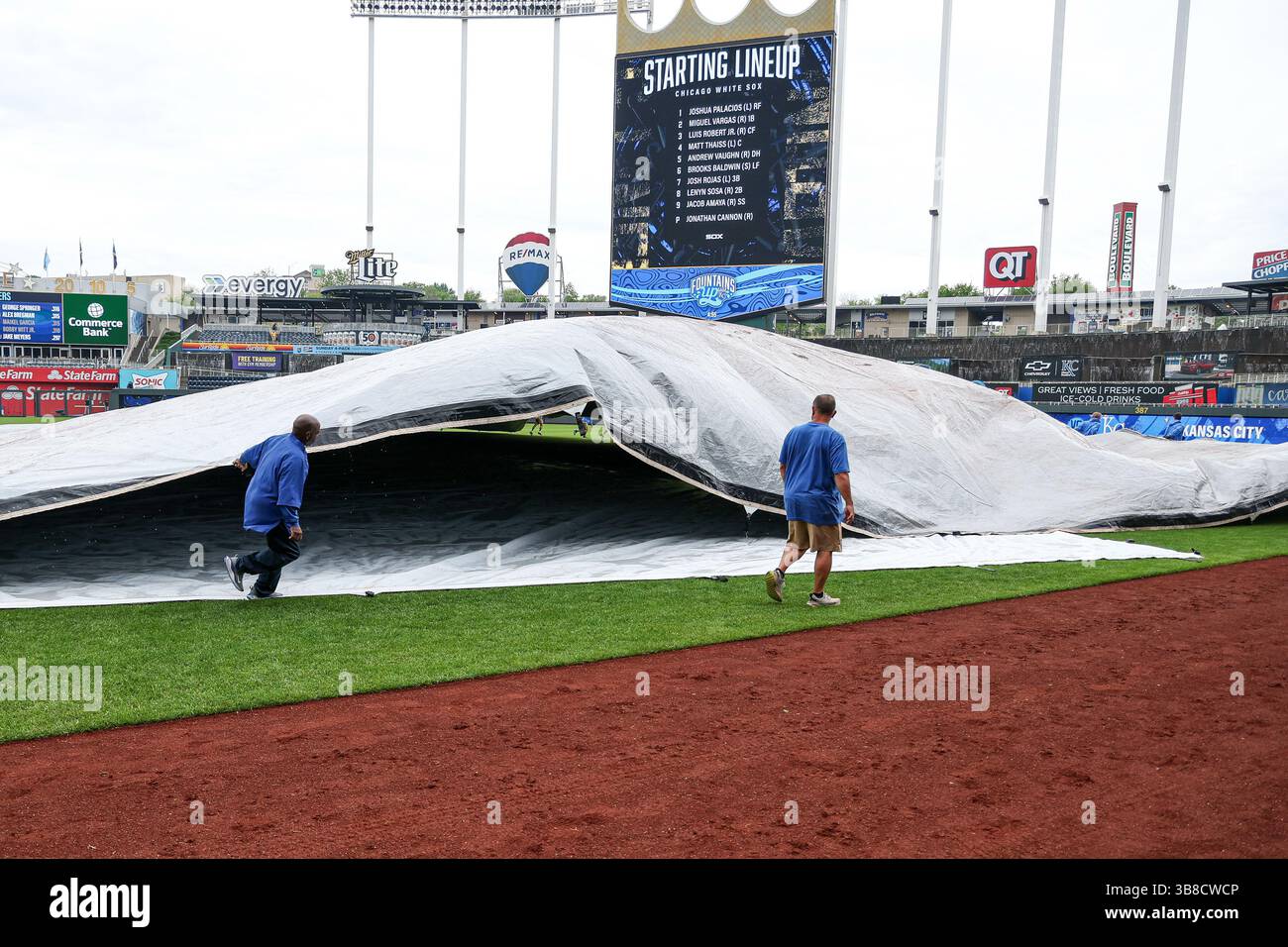 May 7, 2025: The Kansas City Royals grounds crew removes the tarp from ...