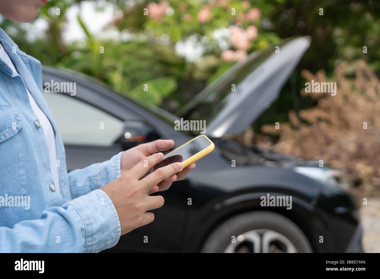 breakdown, broken car, repair. Woman uses mobile phone check insurance ...