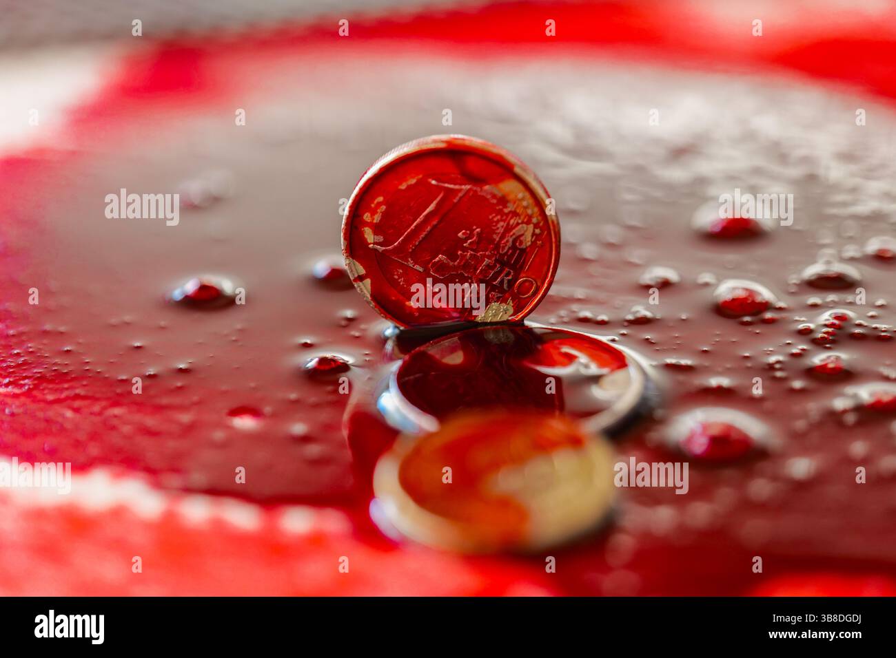 Red blood on coins close hi-res stock photography and images - Alamy