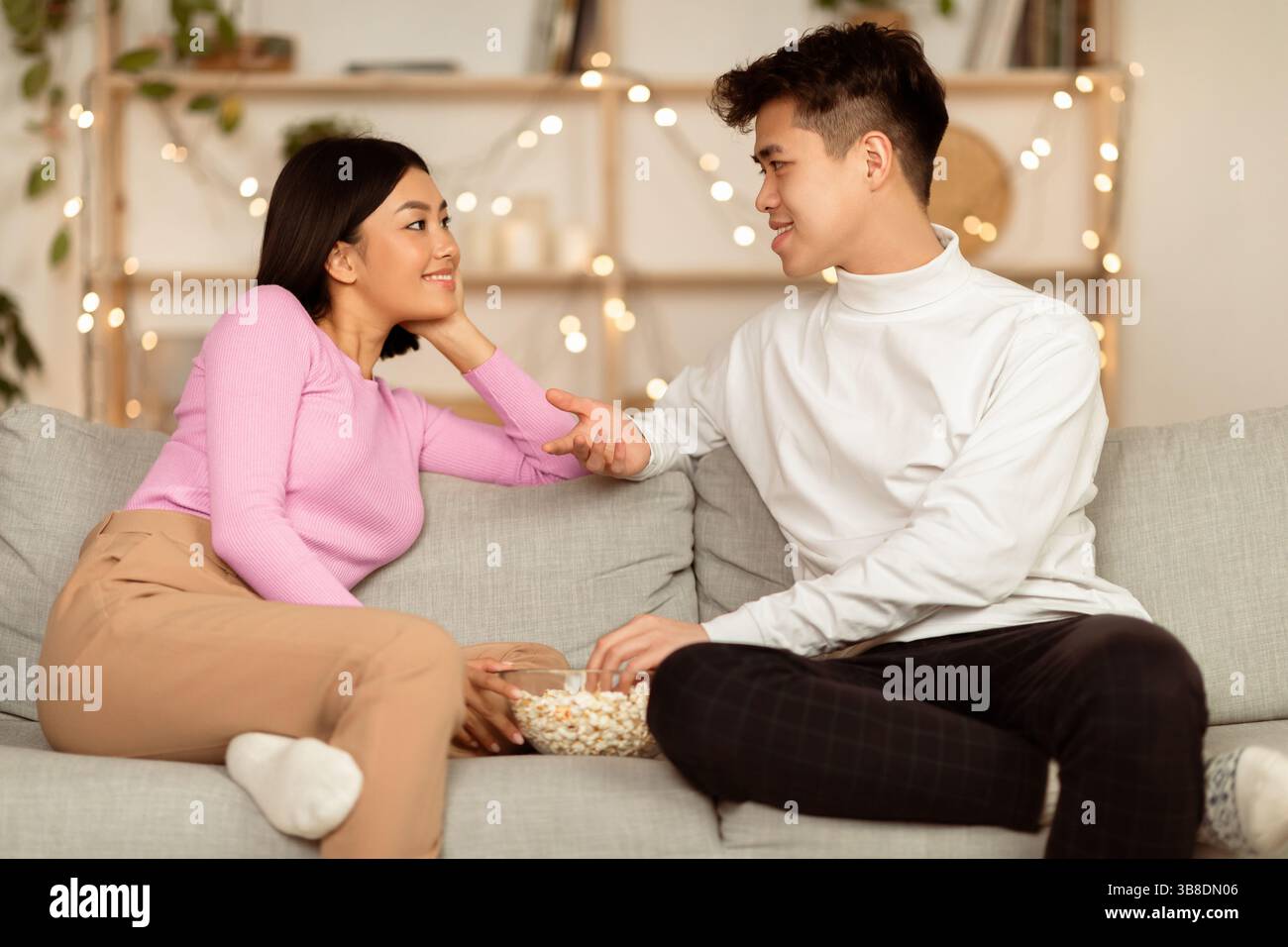 Japanese Couple Talking Enjoying Conversation Eating Popcorn Sitting At ...