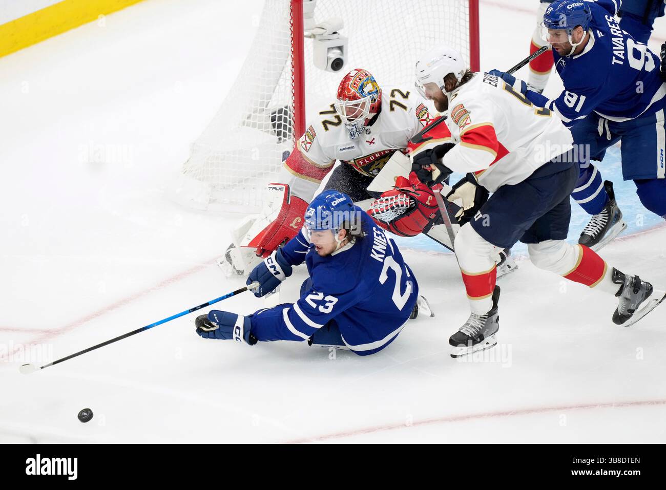 Toronto Maple Leafs' Matthew Knies (23) attempts to corral the puck as ...