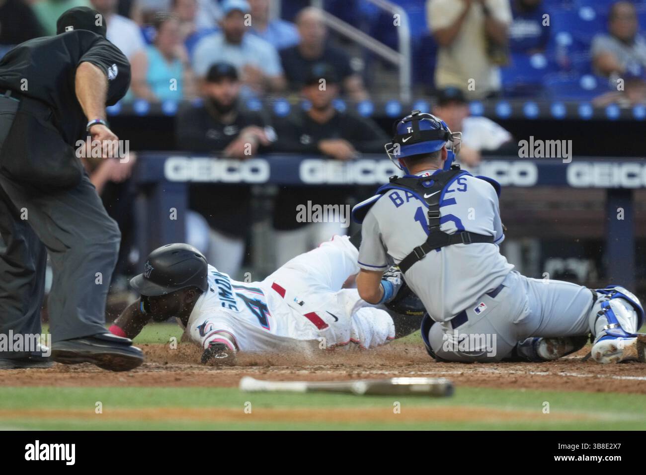 Miami Marlins second baseman Ronny Simon (41) slides into home plate to ...