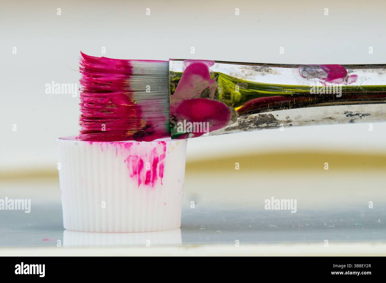 Painting session at school with unrecognizable people mixing all kinds ...