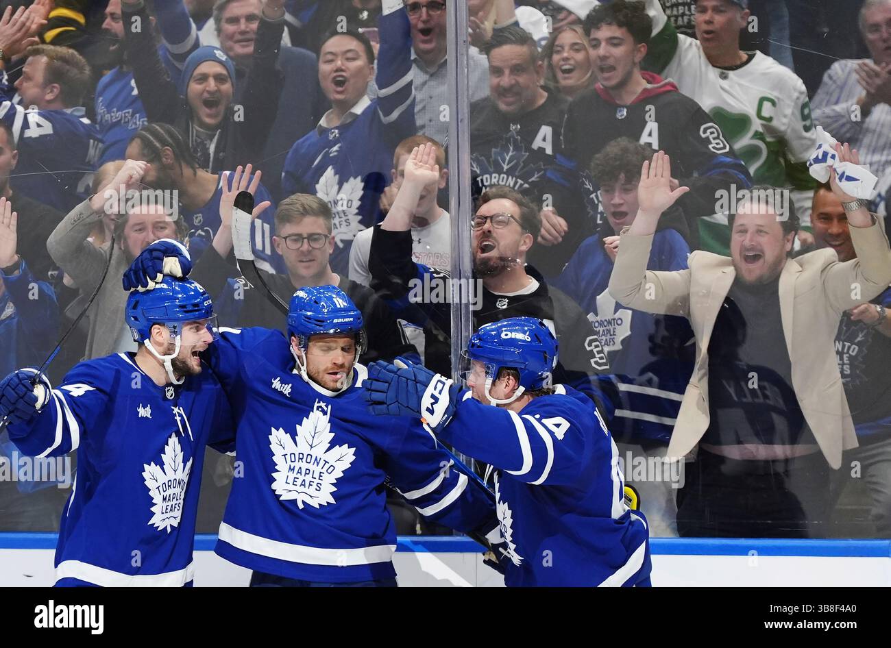 Toronto Maple Leafs' Max Domi (centre) celebrates his goal against the ...