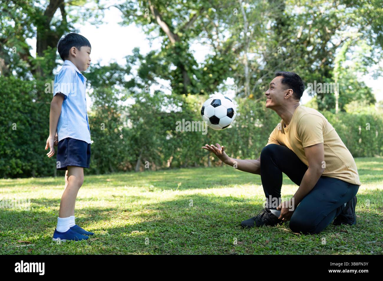 Wellness and joy in father-son bonding during soccer practice Stock ...