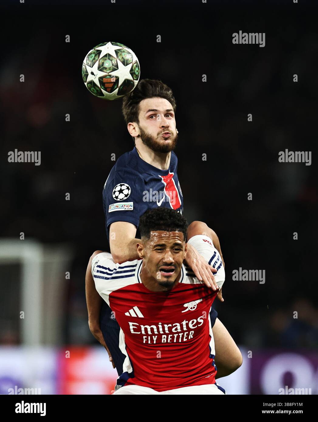 Paris, France. 7th May, 2025. Paris Saint-Germain's Khvicha Kvaratskhelia (top) heads the ball ...