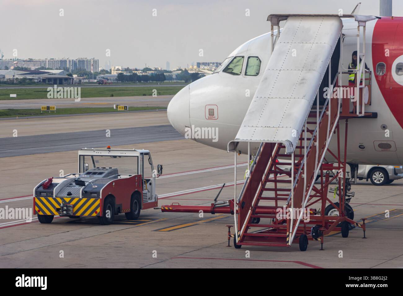 Airplane standing on the runway with attached mobile stairs Stock Photo ...