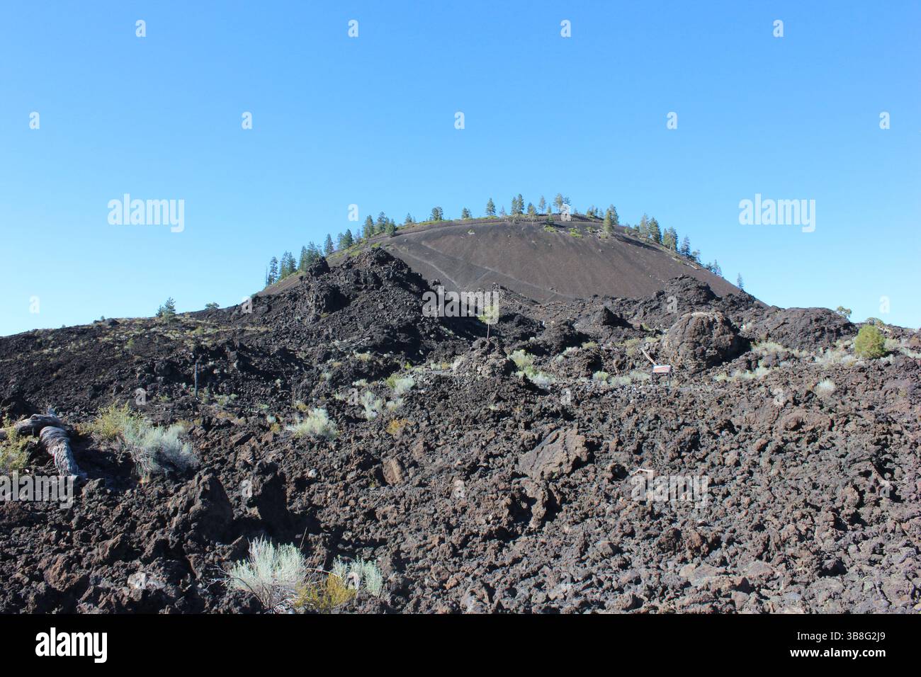 The landscape shows a stark volcanic terrain with a distinct cinder ...