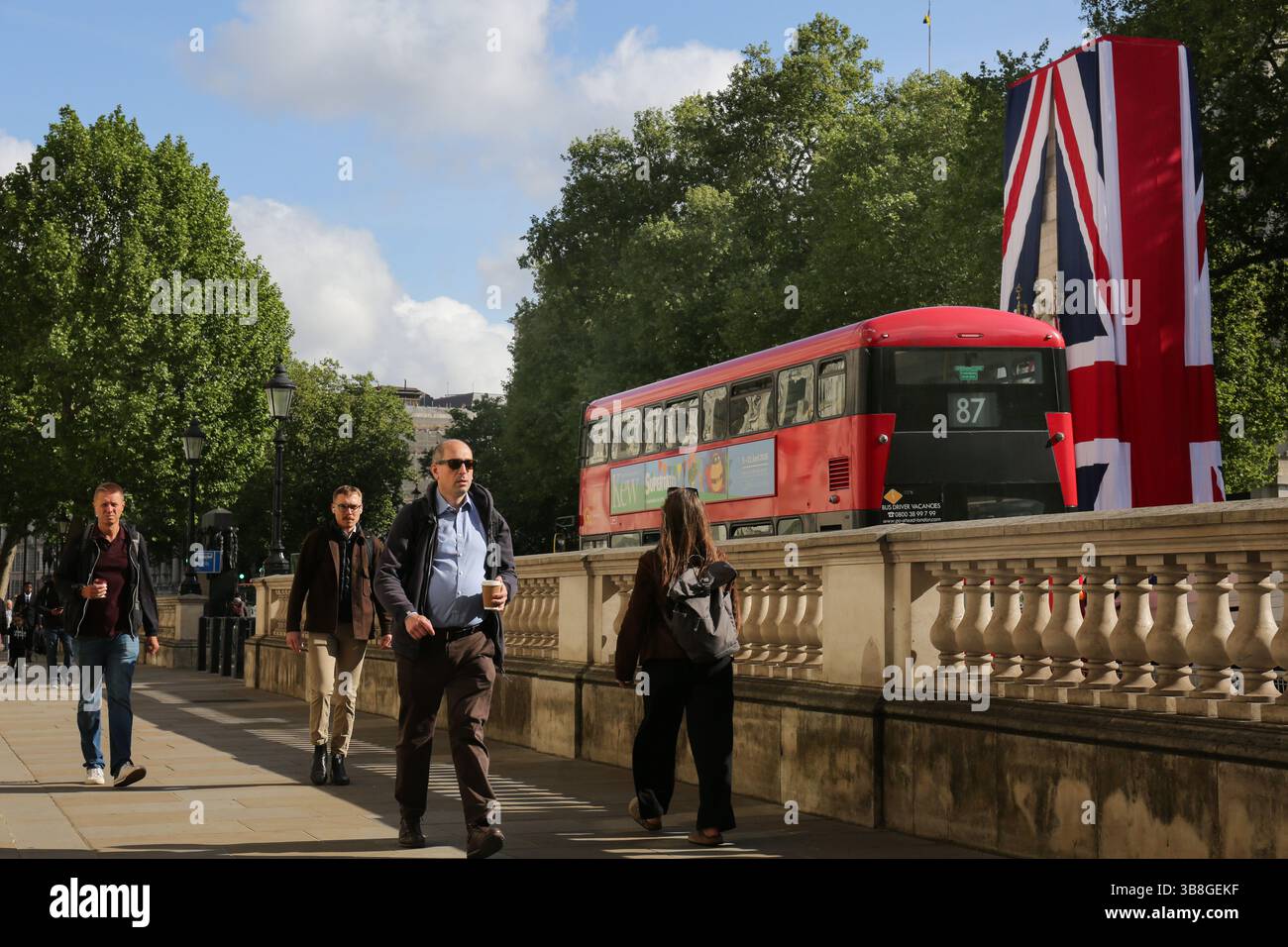 London, UK. 07th May, 2025. People and a London red bus pass the ...
