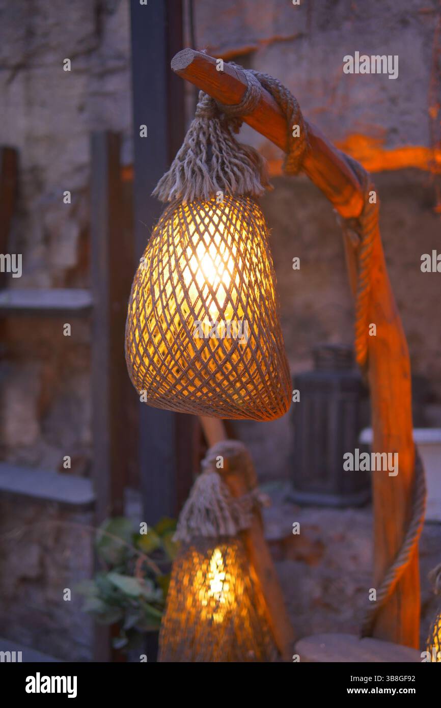 Woven light fixture adds warmth to outdoor gathering space Stock Photo ...