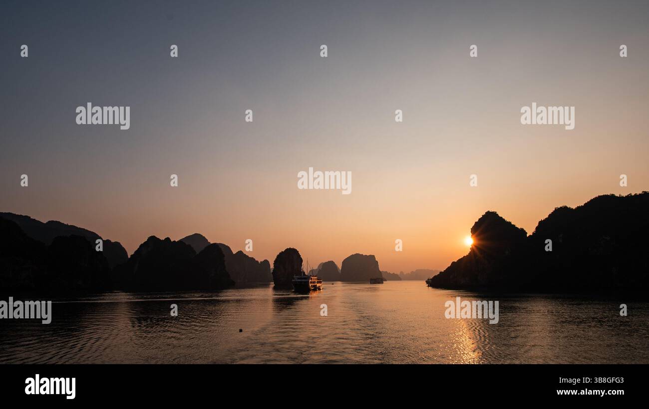 sunrise over Ha Long Bay Stock Photo - Alamy