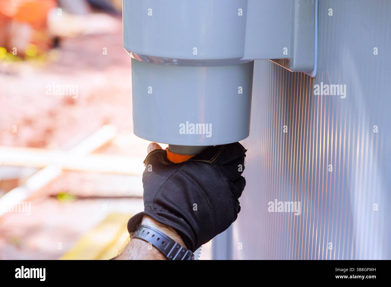 Worker attaching component to filter tank system construction at ...