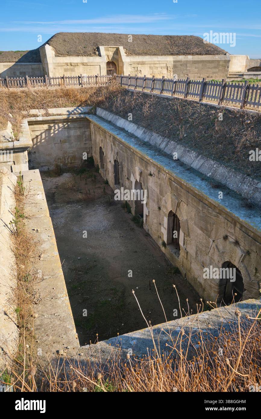 Exterior view of the berm design and fortifications of the complex. At ...