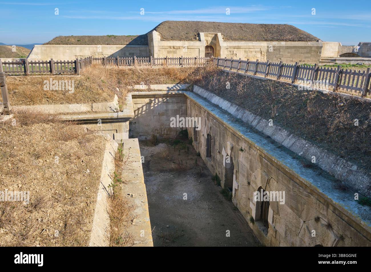 Exterior view of the berm design and fortifications of the complex. At ...