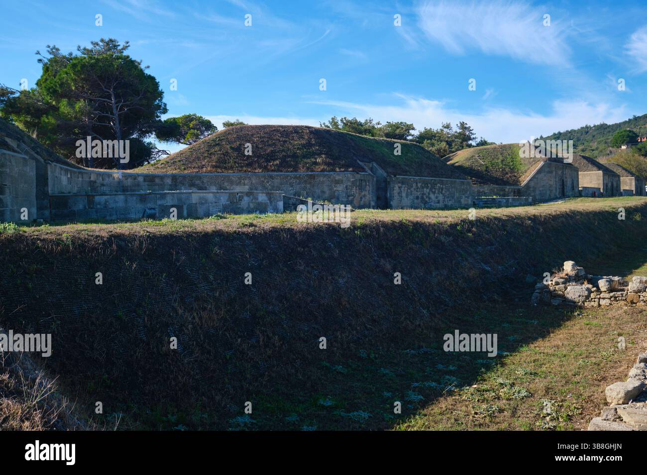 Exterior view of the berm design and fortifications of the complex. At ...