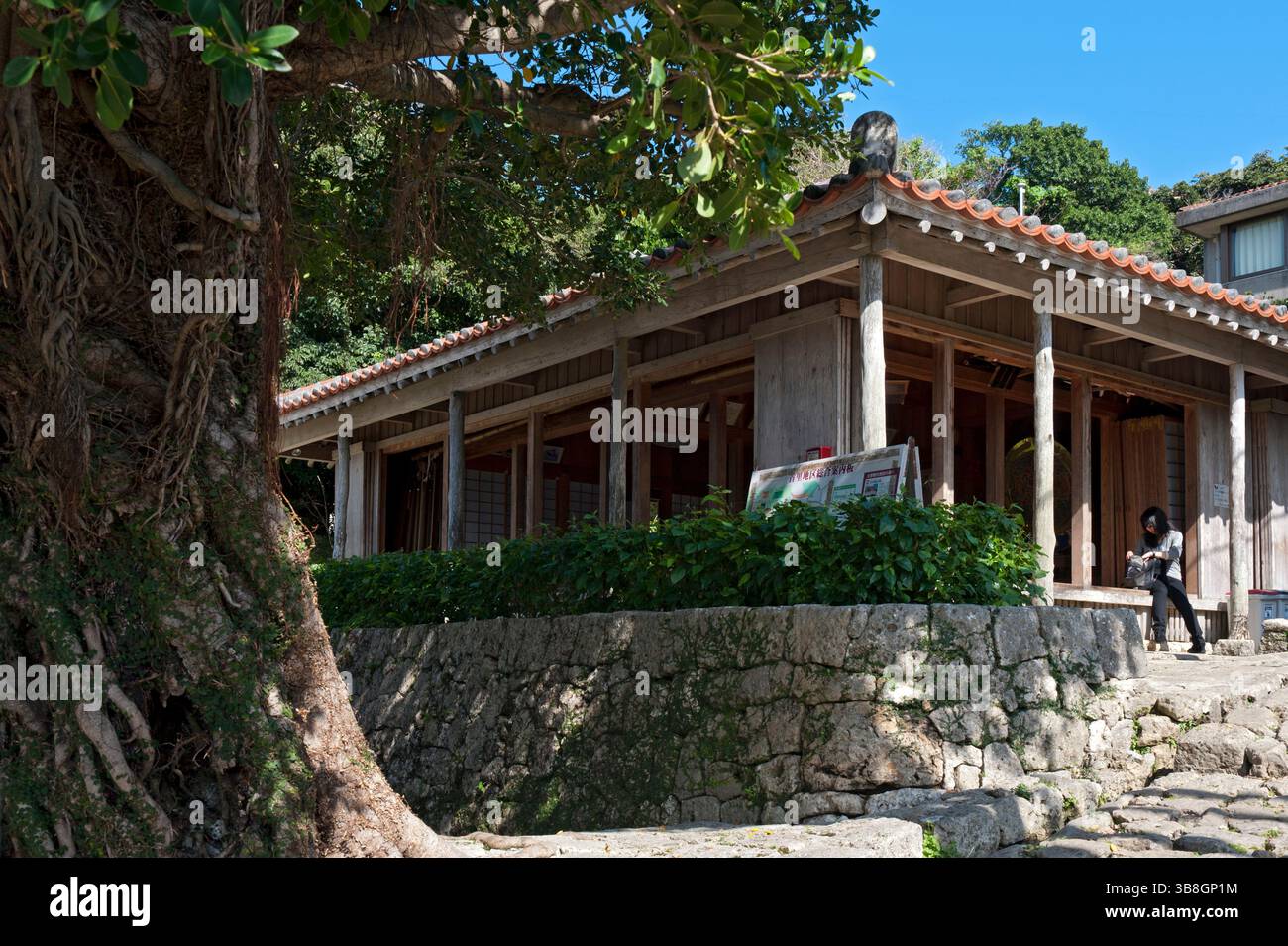 Traditional wood frame construction with stone retaining wall of Naha ...