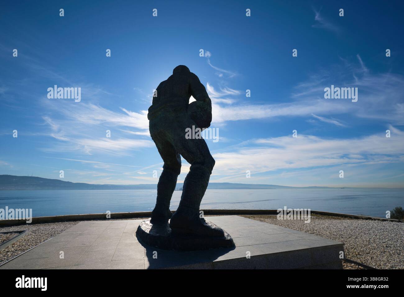 A silhouette view of the hero carrying an artillery shell. At the ...