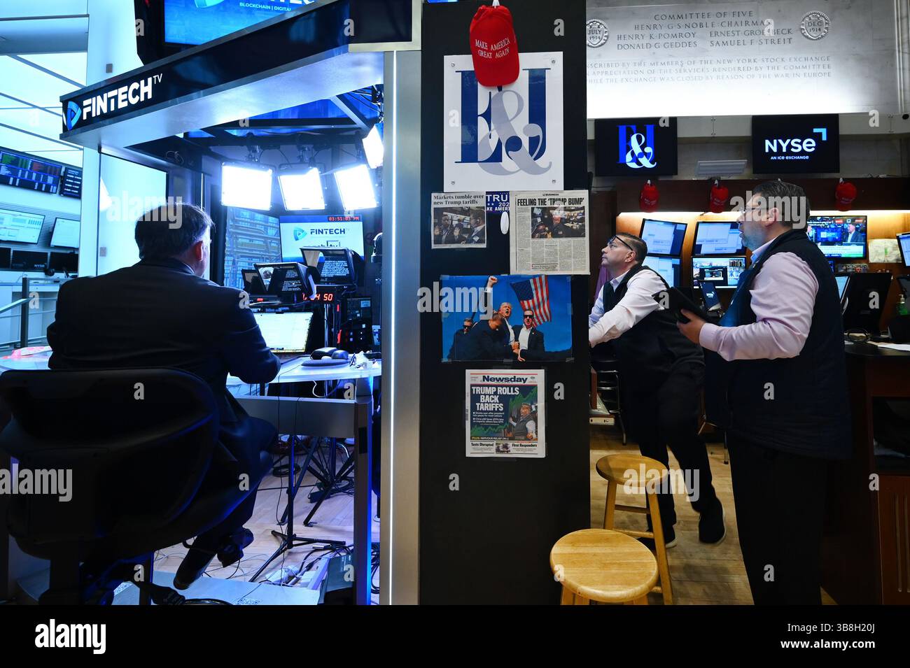 New York, USA. 07th May, 2025. A reporter (l) broadcast live as stock ...