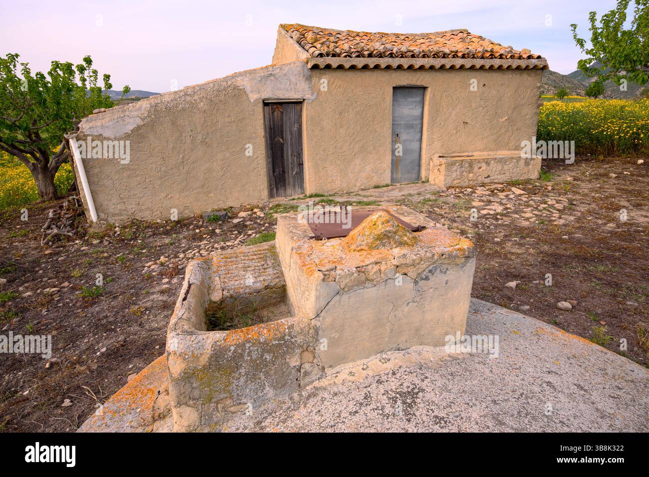 small rustic house with well and "pila" to washing clothes in the ...