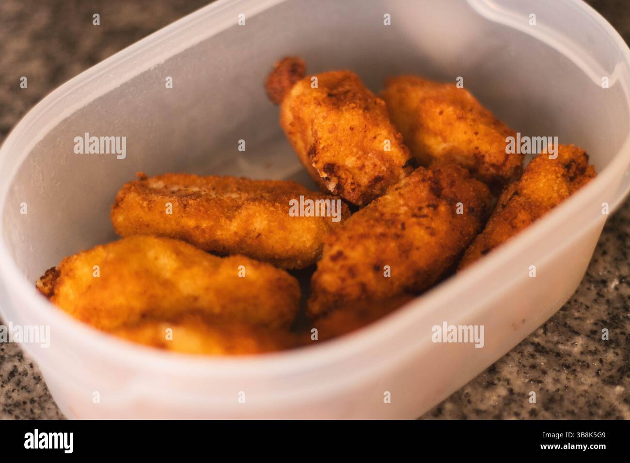 Homemade croquettes stored in a Tupperware container on a kitchen ...