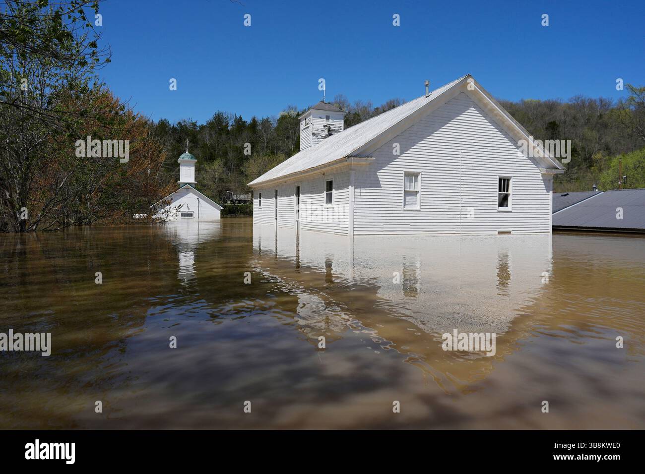 FILE - Two churches, one Catholic and one Baptist are flooded by the ...