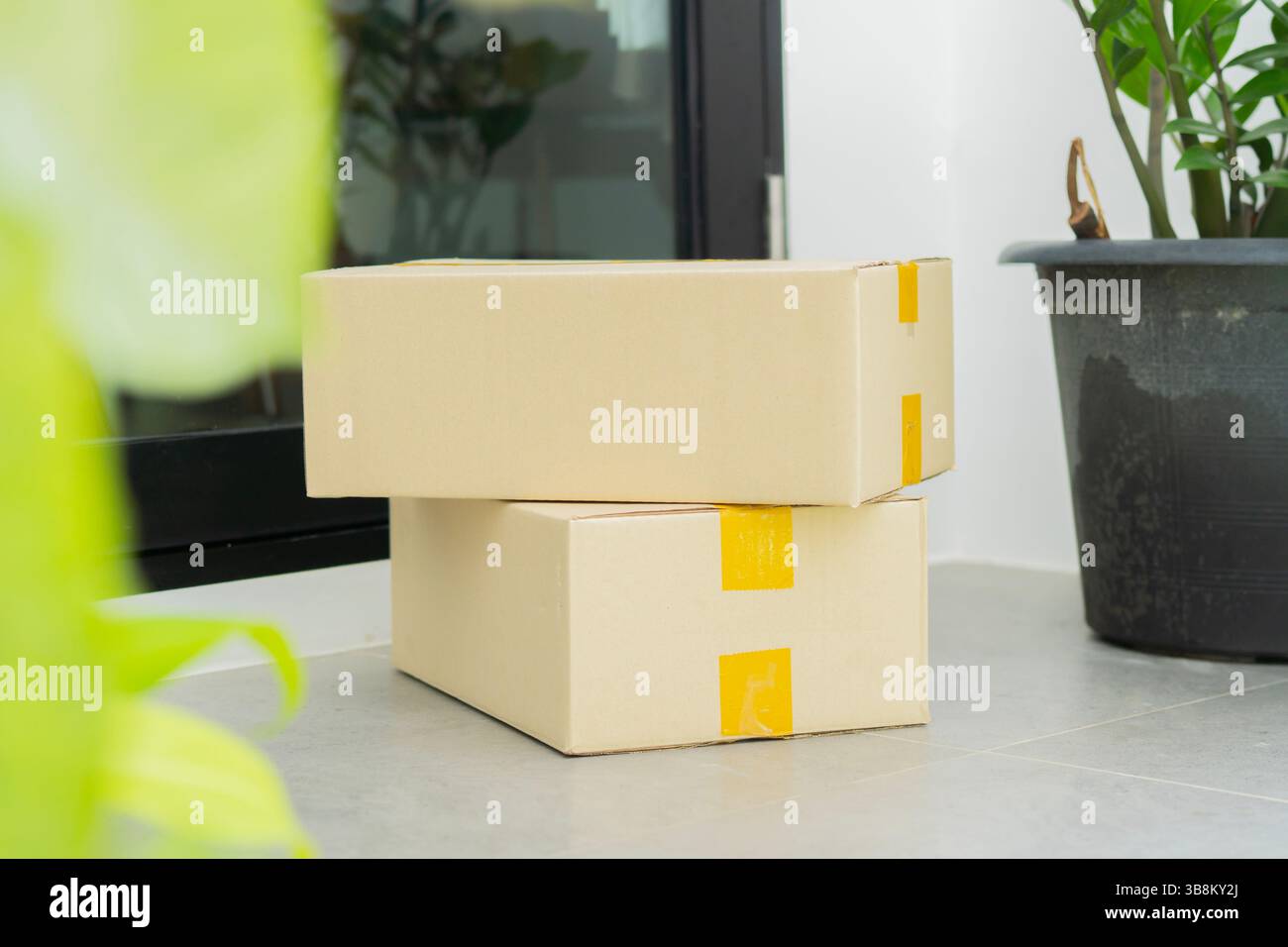 Cardboard boxes near door. Parcel delivery service. Delivered outside ...