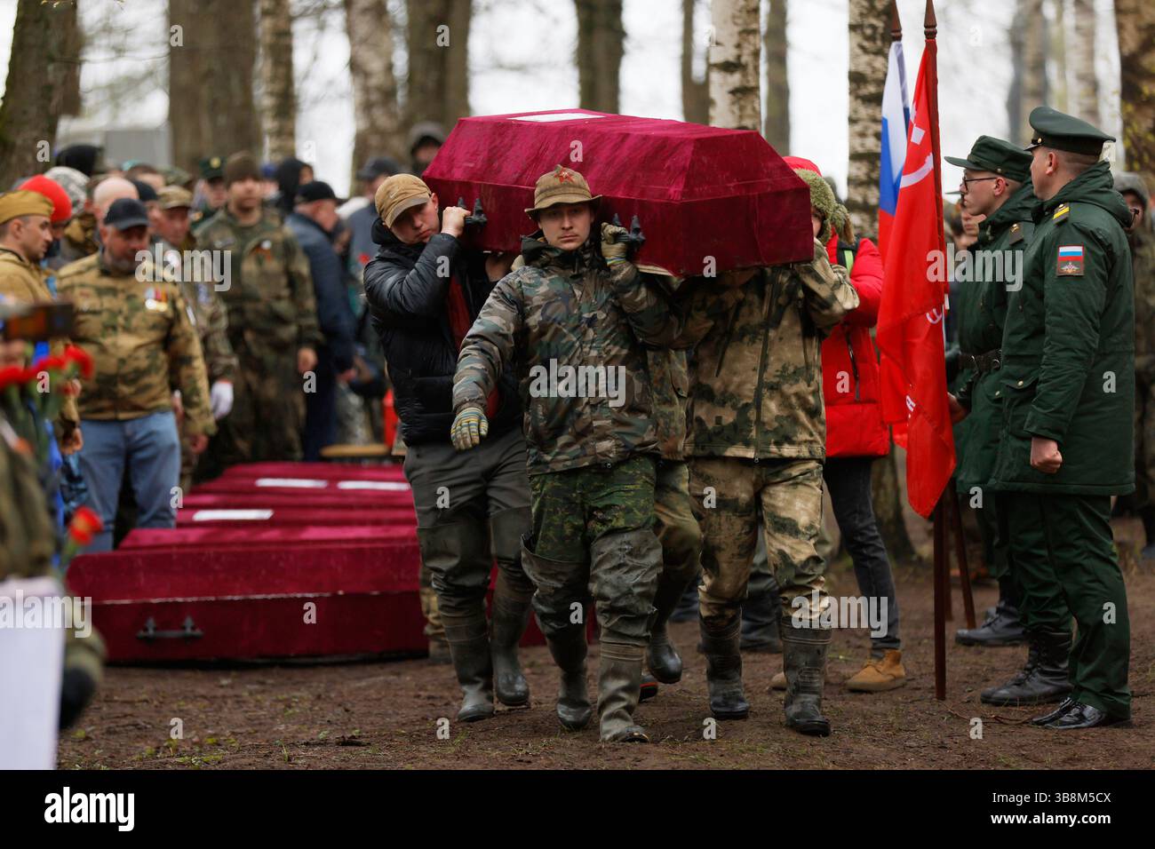 Members of volunteer search teams carry coffins with the remains of ...