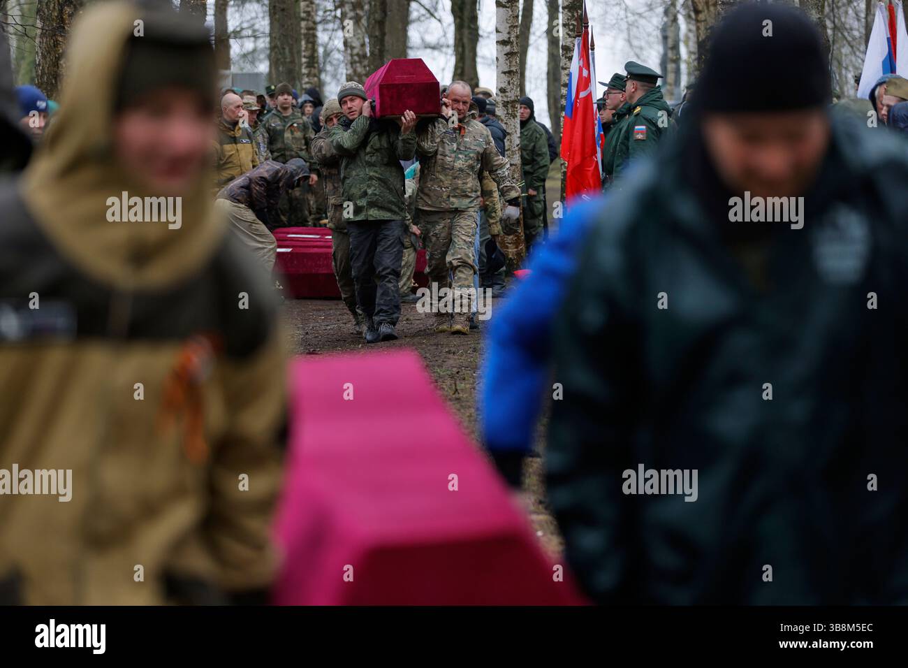Members of volunteer search teams carry coffins with the remains of ...