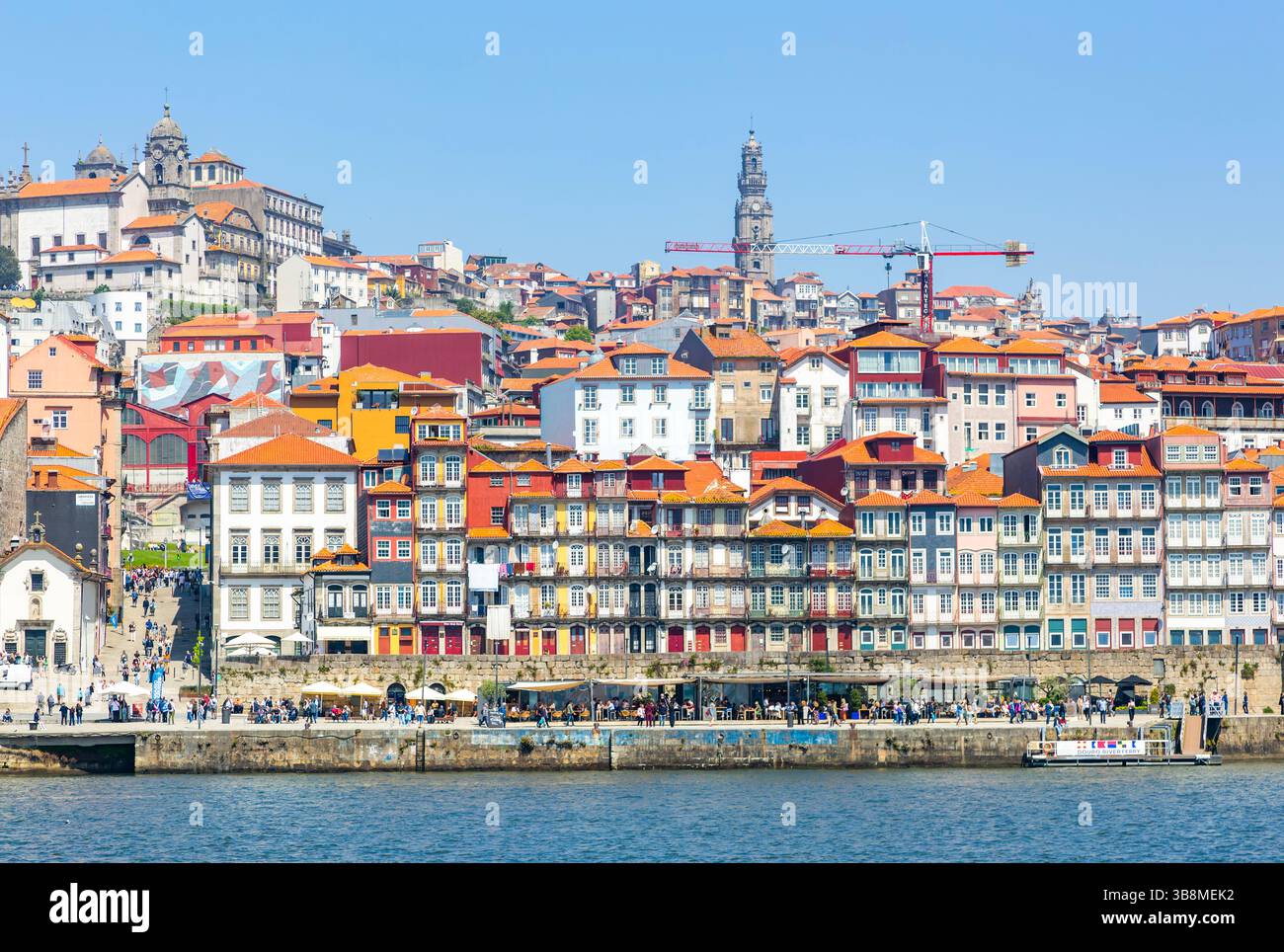 Historic riverside buildings on hillside of Ribeira next to River Douro ...