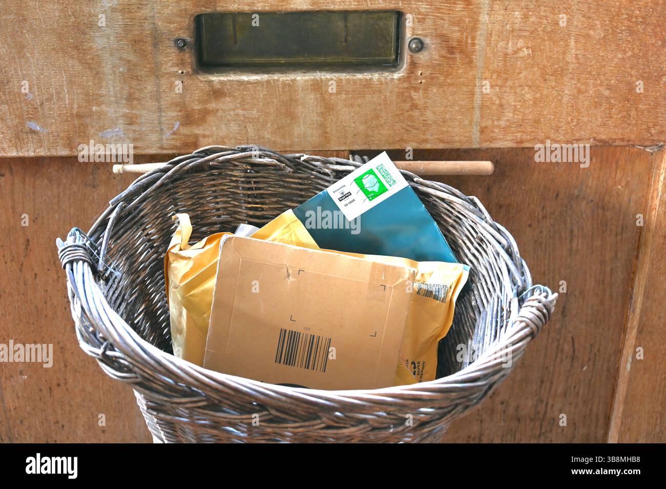Mail collecting basket with King Charles stamp on letter Stock Photo ...