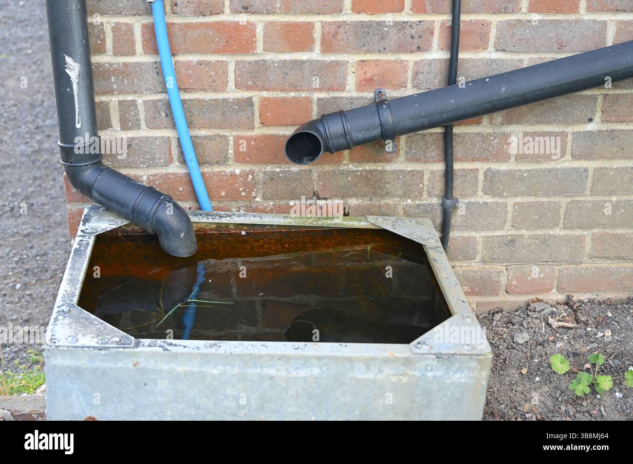 Water container and pipes in English garden Stock Photo - Alamy
