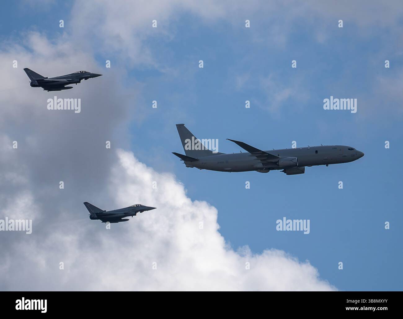 A Royal Air Force Boeing Poseidon MRA1 escorted by two Eurofighter ...