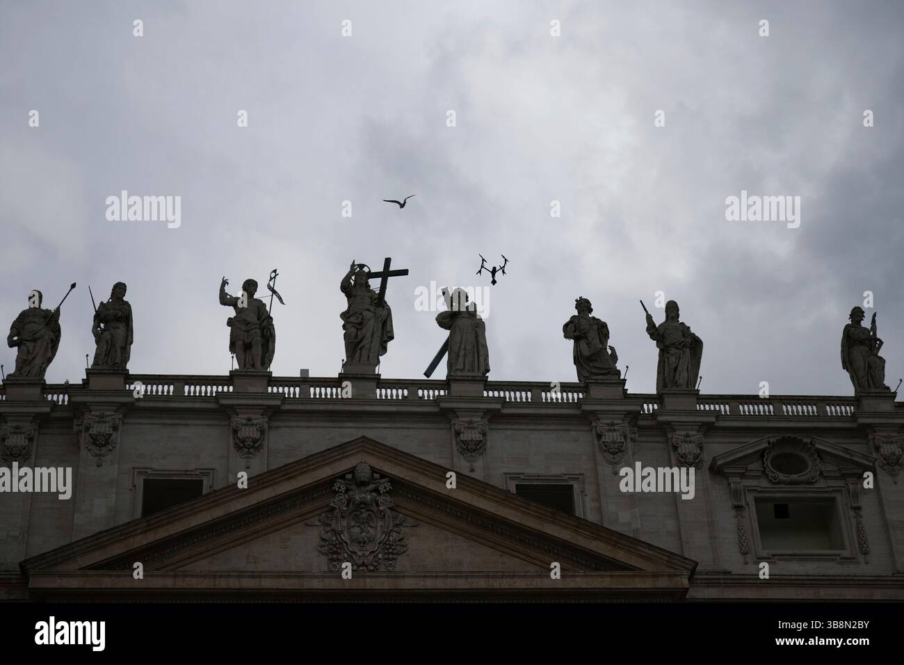 A seagull and a drone fly above St. Peter's Basilica on the second day ...
