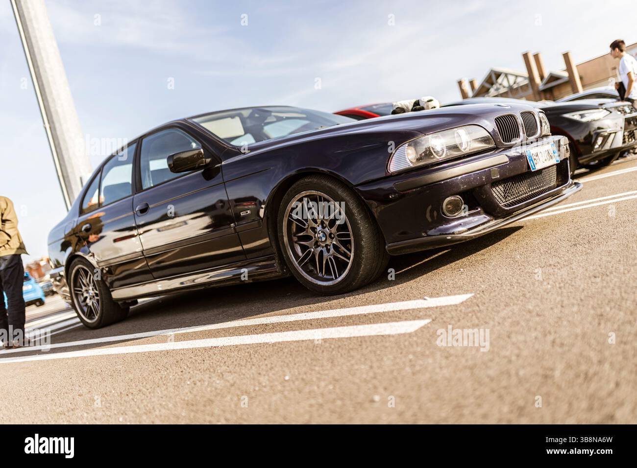 Rome, italy 4 may 2025: dark blue bmw m5 parked in a parking lot with ...
