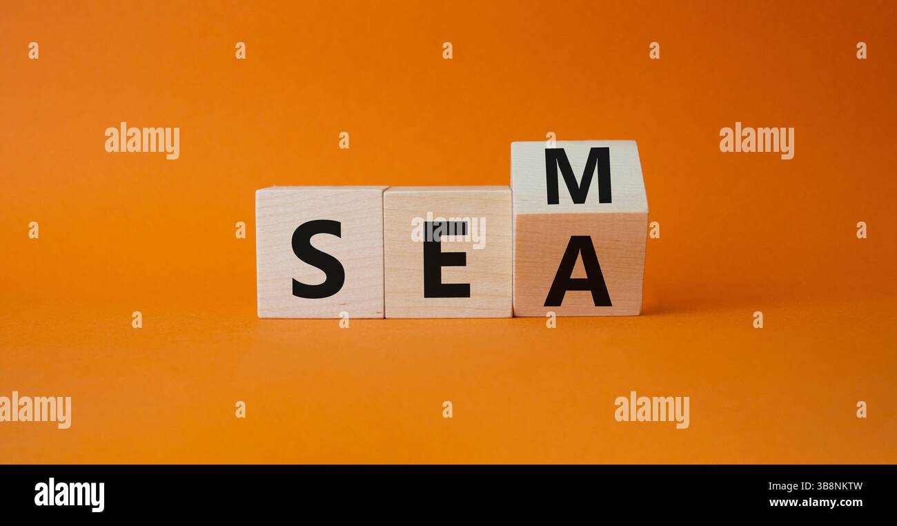 SEM vs SEA symbol. Turned wooden cubes with words SEA and SEM ...